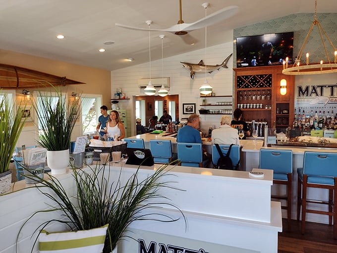 The bar area—where locals swap fishing tales and visitors quickly become regulars, all under the watchful eye of a mounted marlin.