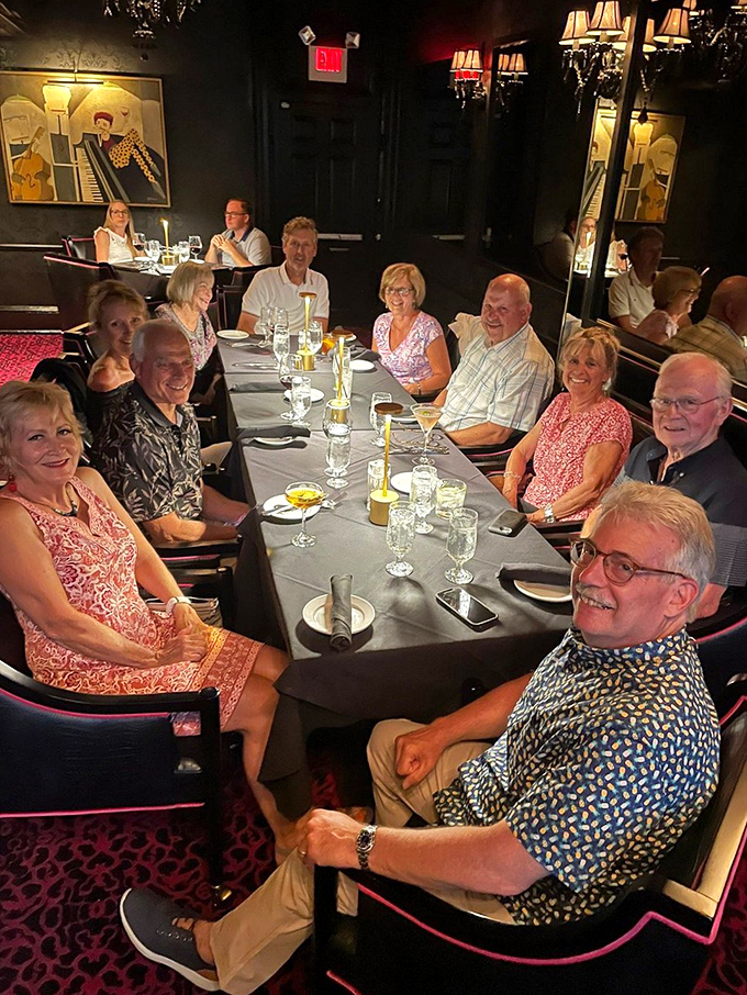 Happy diners gathered around a table laden with possibilities. This is what restaurants are really about—connection over exceptional food.