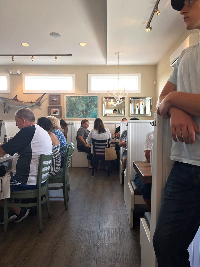 The dining room buzzes with the happy murmur of people having religious experiences with seafood. Notice nobody's looking at their phones—the food demands full attention.