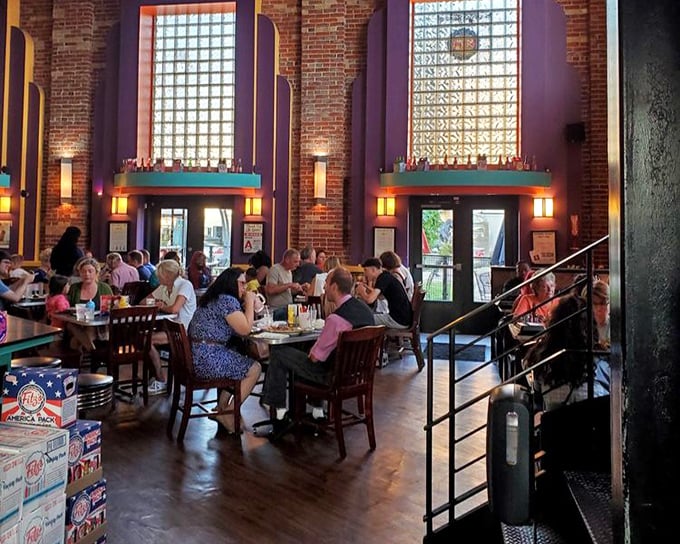 The dining area buzzes with conversation and anticipation—wooden chairs, brick walls, and the promise of comfort food creating that perfect neighborhood vibe.