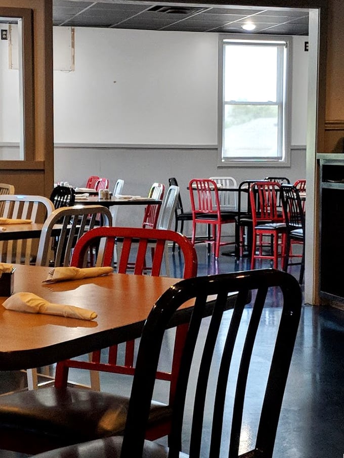 The dining area's mix of red and silver chairs creates that perfect balance of "hip enough to be cool, familiar enough to feel at home."