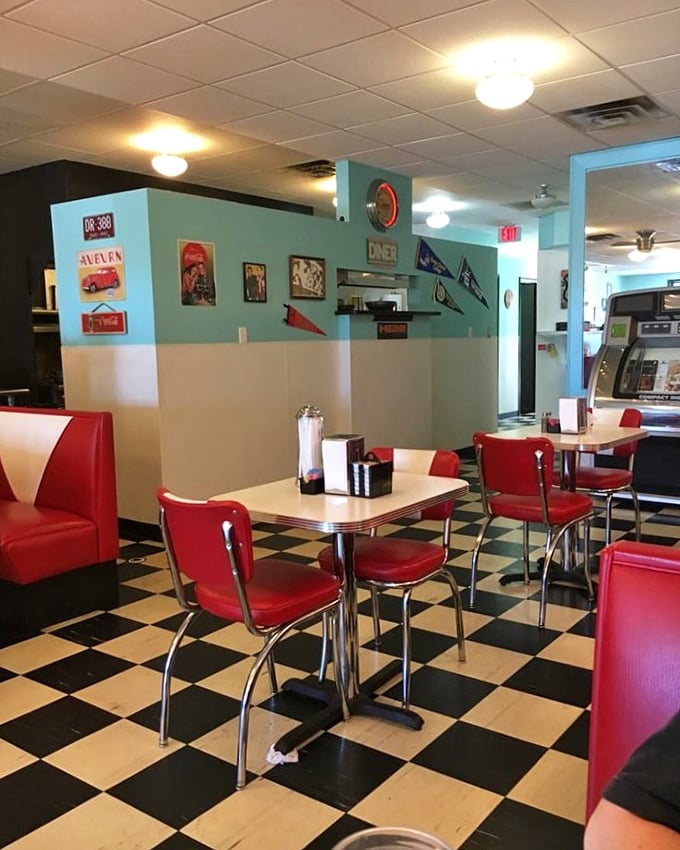 The dining area balances nostalgia with comfort – turquoise walls, vintage car photos, and booths that have cradled countless conversations and coffee refills.