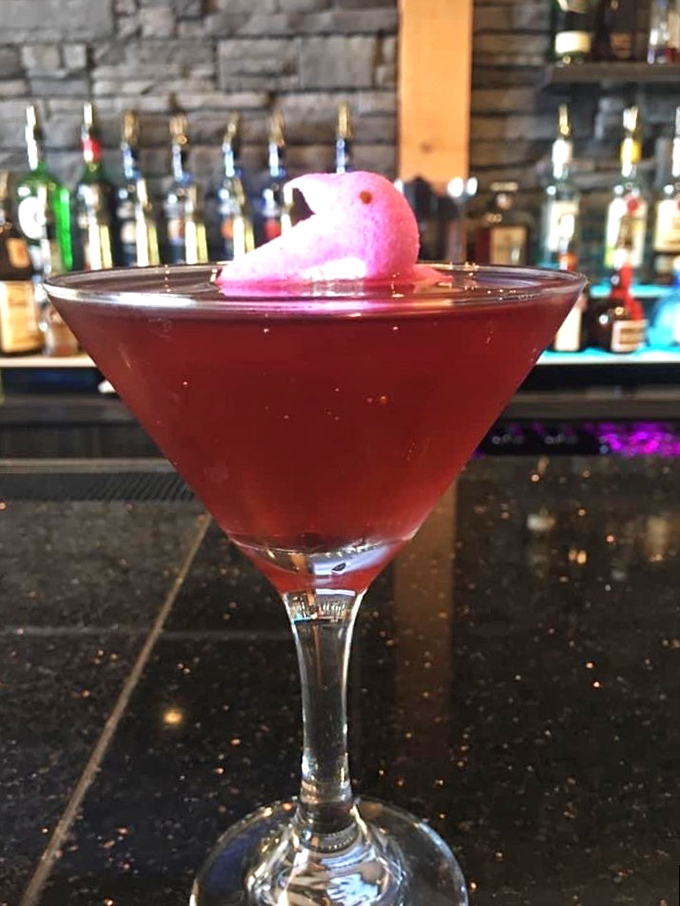 Cocktail artistry in a martini glass. That pink garnish isn't just for looks – it's the exclamation point at the end of a liquid sentence.