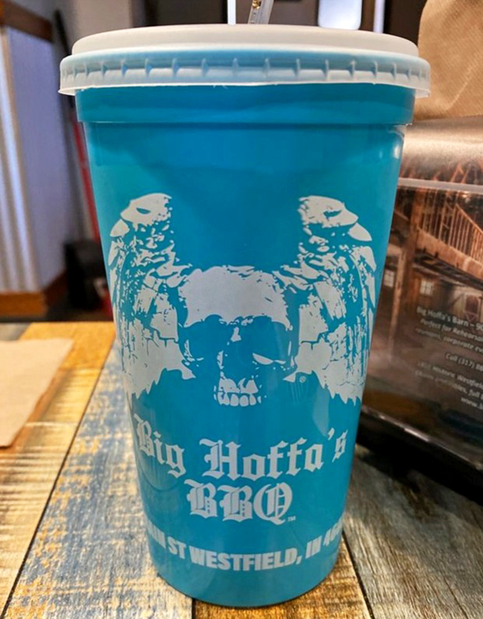 The signature blue cup isn't just a vessel—it's a pirate-themed badge of honor that says, "Yes, I've discovered the BBQ treasure of Indiana."