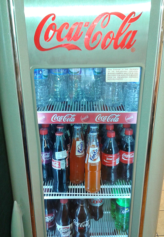 The vintage Coca-Cola cooler isn't just storing drinks—it's preserving a slice of Americana. Cold soda and fried chicken: a pairing as timeless as Bogart and Bacall.
