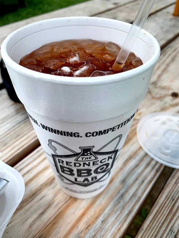 Sweet tea served in its natural environment—a branded cup on a wooden picnic table. The unofficial wine pairing for all things smoked.