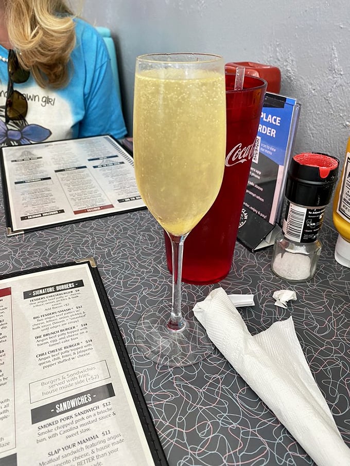 Bubbles rising in a champagne flute next to well-worn menus – because sometimes Tuesday deserves to dress up as Saturday night.