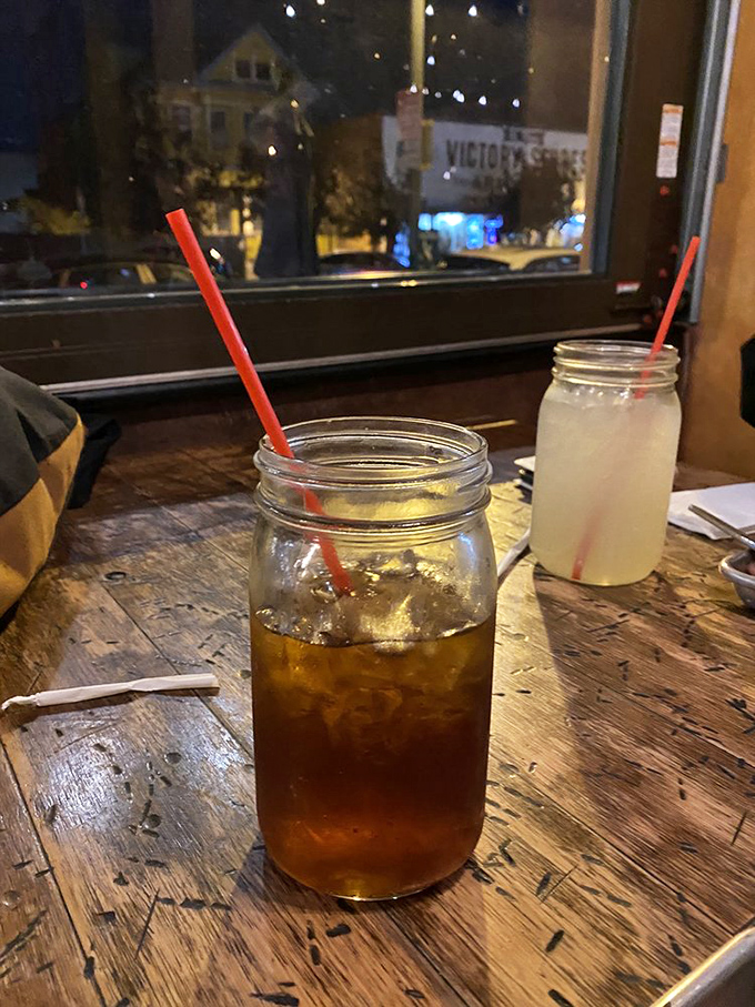 Sweet tea in mason jars—the unofficial state beverage of "y'all come back now." That weathered wooden table has heard a thousand satisfied sighs.