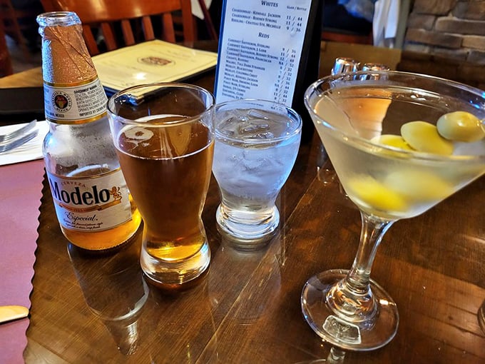 The holy trinity of adult refreshment: cold beer, crisp water, and a martini with olives standing at attention. Liquid companions for the meat feast to come.
