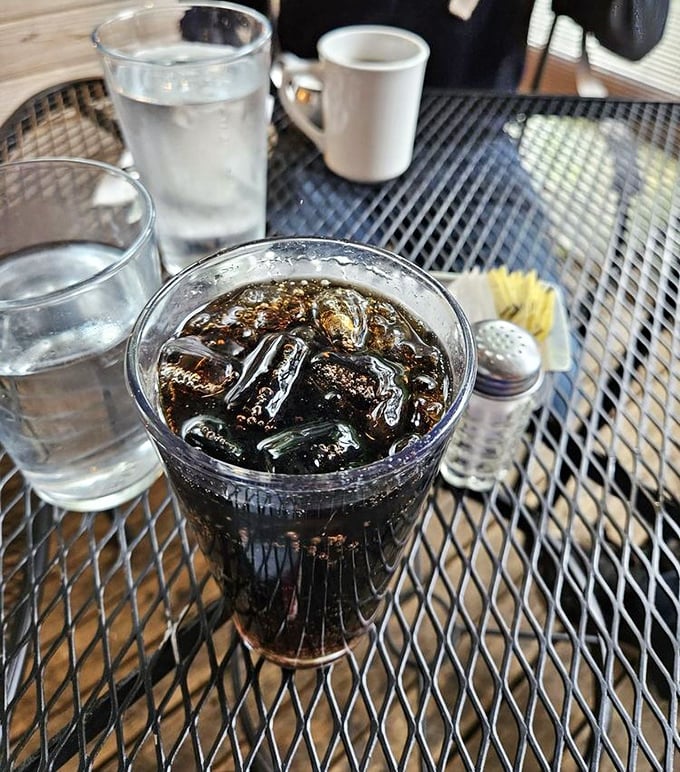 Even the beverages at Cafe Du Berry demand attention—this cola, perfectly iced, sits ready to complement your breakfast adventure.