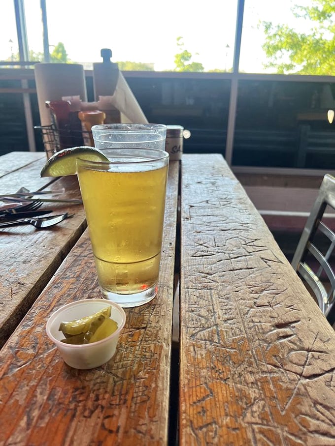 Cold beer and pickle spears—a Texas tradition as sacred as high school football. That wooden table has stories to tell, and so will you.