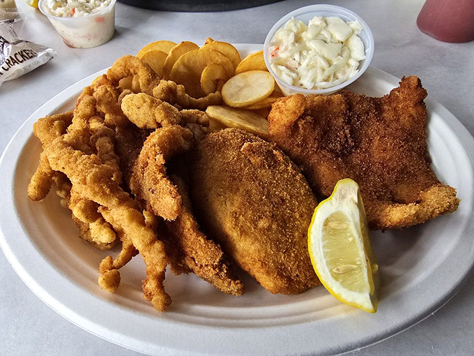 A seafood sampler that hits all the right notes. Crispy fish, golden shrimp, and those signature sea chips—the ocean's greatest hits album.