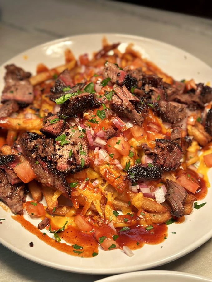 Loaded fries that break all the rules: Smoky brisket, melty cheese, and fresh toppings create a fork-worthy masterpiece that demands to be shared.
