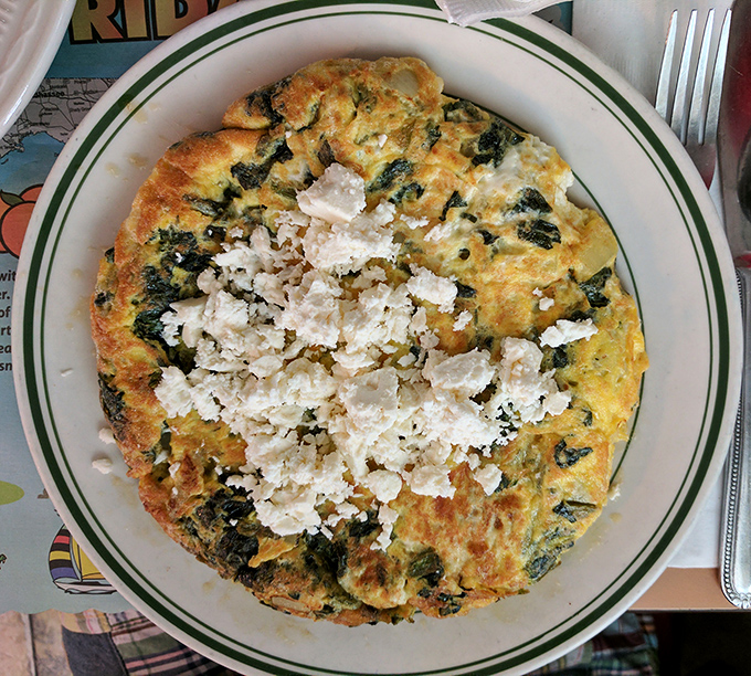 A frittata that's having an identity crisis as a pizza—and we're here for it. Spinach and feta create a Greek holiday on a classic diner plate.