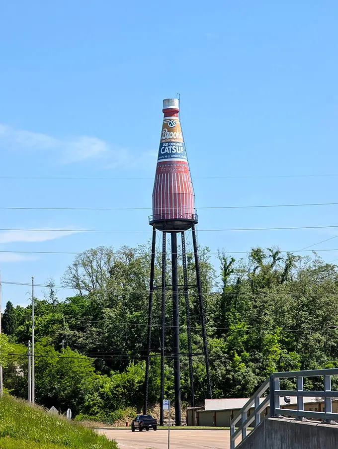 Against a perfect blue sky, the bottle's vintage design elements shine. Madison Avenue meets Main Street in this perfectly preserved advertisement.
