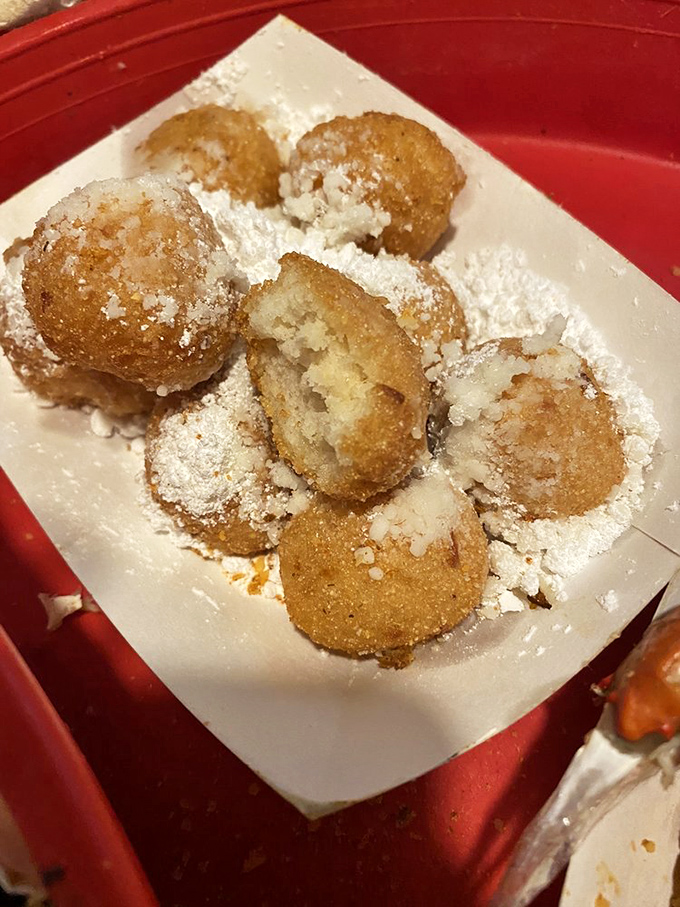 Hush puppies dusted with powdered sugar—Southern comfort in bite-sized form. Like donut holes that went to seafood finishing school.