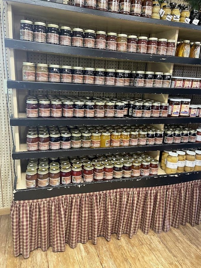Jam jars lined up like soldiers of sweetness. Each contains summer captured in glass – ready to transform your ordinary toast into something extraordinary.