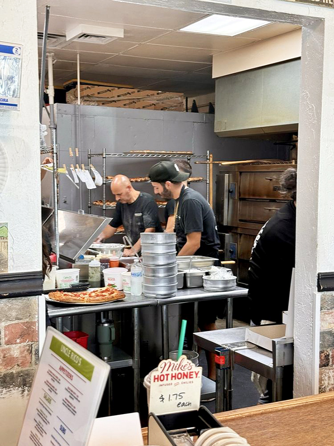 The kitchen reveals the beautiful choreography behind great pizza – where dough-tossing and topping-arranging become an art form right before your eyes. 