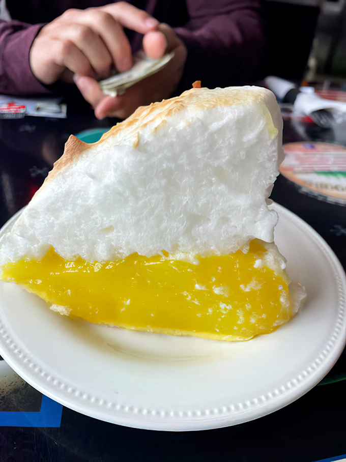 Lemon meringue pie towering with clouds of sweetness – the kind of dessert that makes grown adults giggle with delight.