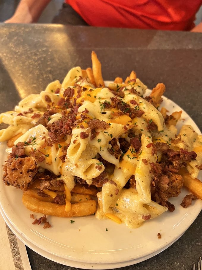 Loaded fries that don't just cross the line into decadence – they pole vault over it with pasta, cheese, and meat in a carb carnival.