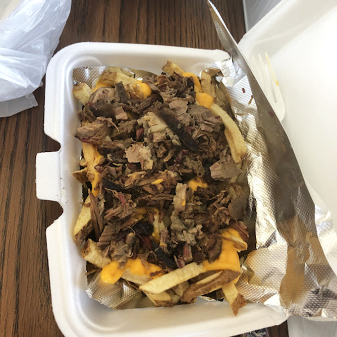Meat-topped fries: where comfort food meets carnivorous delight in a styrofoam container of pure genius.