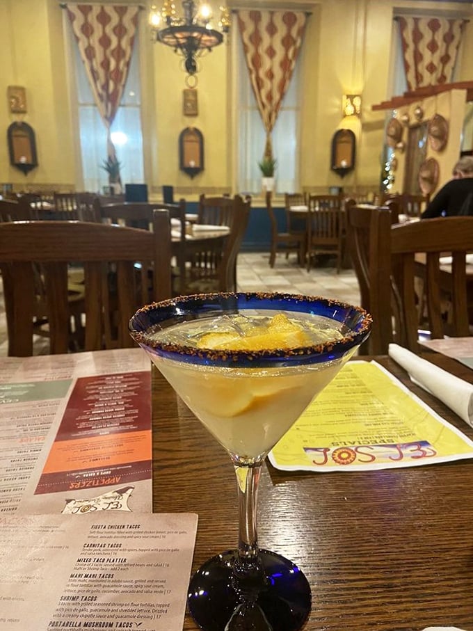 A proper margarita with its salt-rimmed blue edge—like the ocean meeting the beach in cocktail form, minus the sunburn and sand.