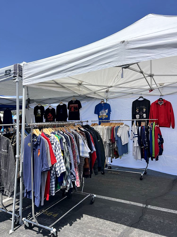 Vintage clothing racks bursting with decades of fashion history. Someone's 1980s concert shirt is about to become someone else's ironic statement piece.