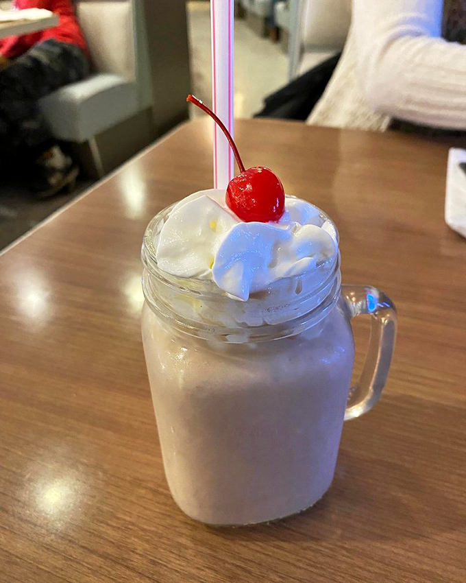 That mason jar milkshake isn't just dessert—it's a commitment. The cherry on top isn't garnish; it's a promise of good things to come.