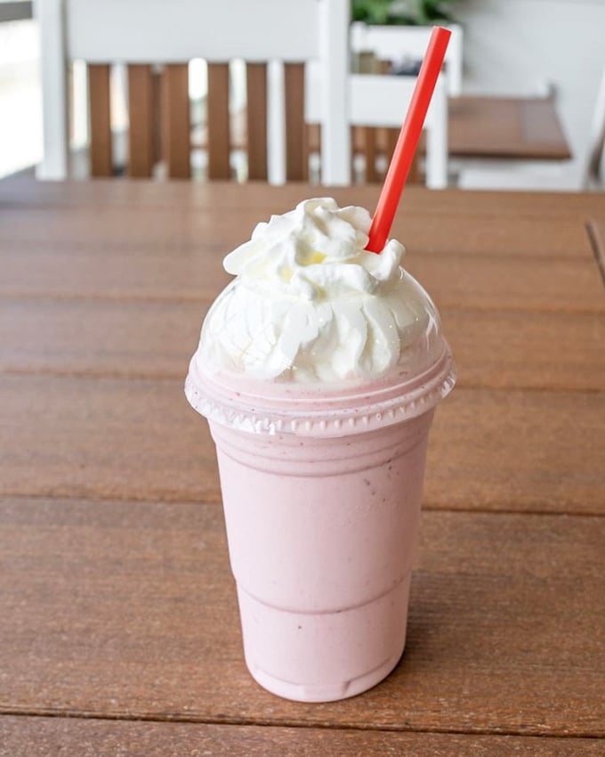 This strawberry milkshake isn't just a drink—it's summer in a cup, topped with enough whipped cream to make your diet plan file for divorce.