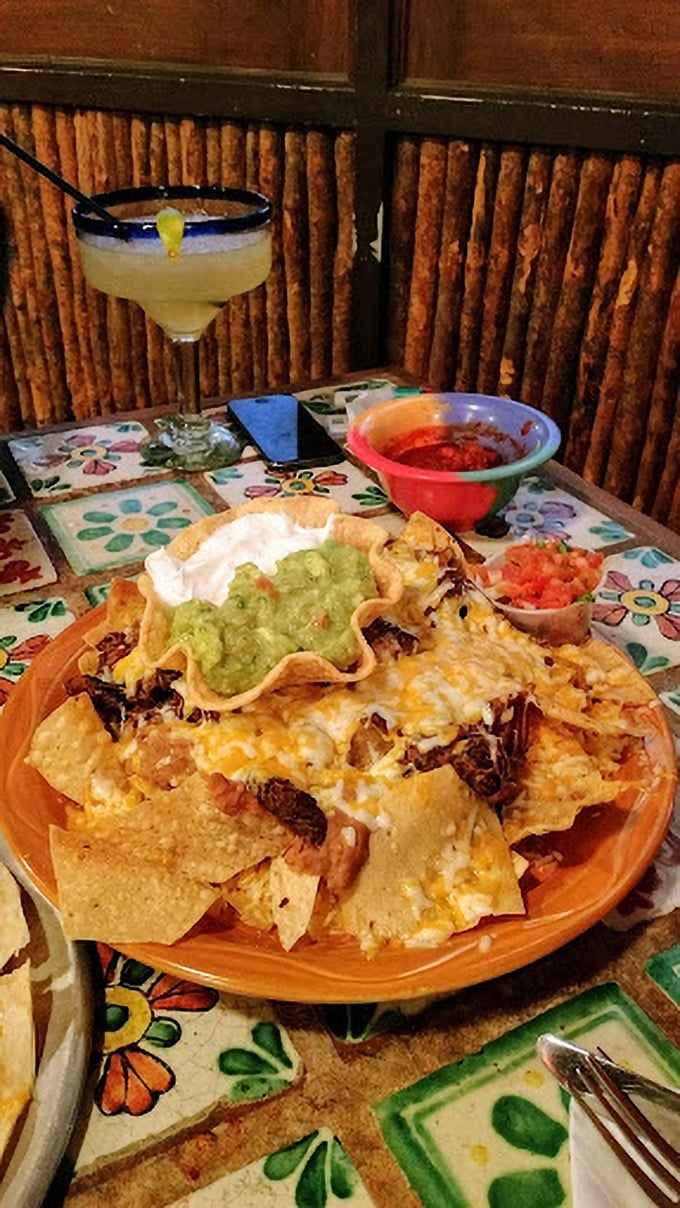 These nachos aren't playing around—loaded with toppings and served in that edible tortilla bowl that makes you feel like you've won at life.