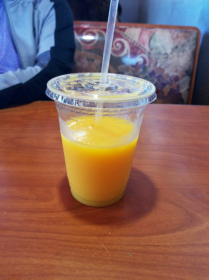 That orange juice isn't from a carton or concentrate—it's liquid sunshine in a cup, the perfect palate cleanser between burger bites.