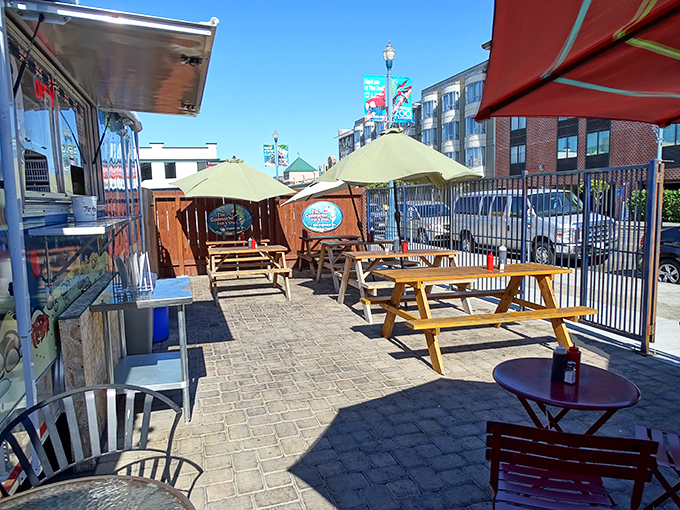 Picnic tables under blue skies create the perfect casual dining atmosphere—because great fish and chips taste even better with a side of fresh air.