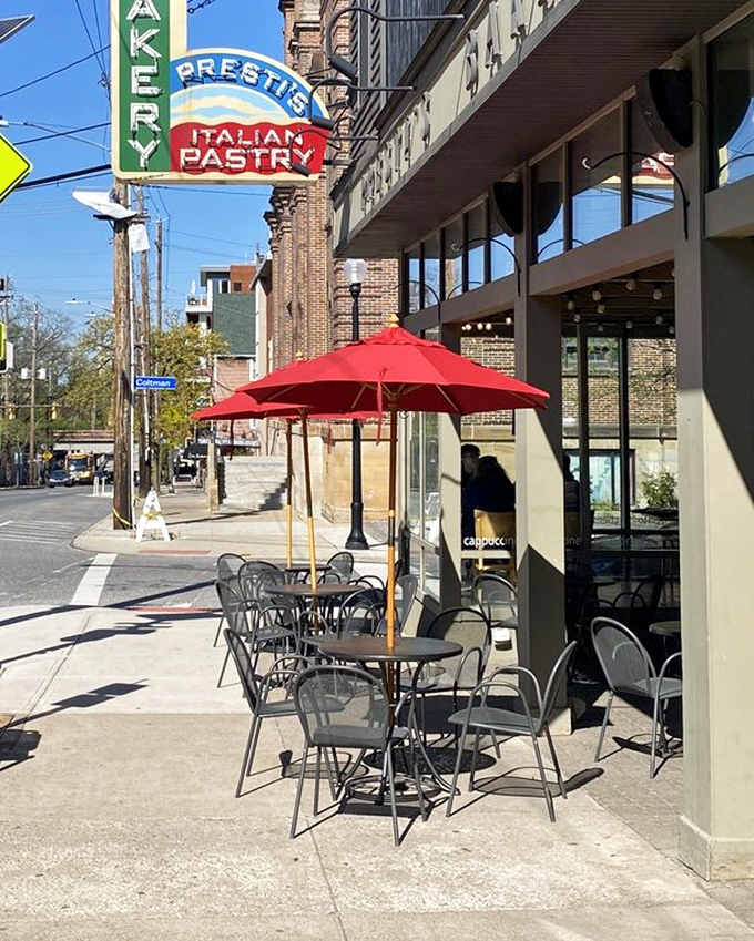 Red umbrellas beckon you to enjoy your pastries al fresco while soaking in Little Italy's authentic neighborhood charm.