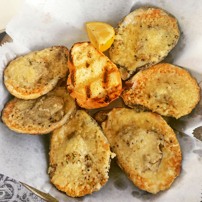 Golden halos of seafood perfection. These chargrilled oysters aren't just appetizers—they're little miracles that could convert even the most stubborn oyster skeptic.