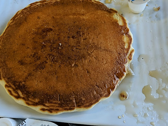 This golden pancake isn't just breakfast—it's a canvas of possibility, a disc of perfection that puts those fancy brunch spots' "flapjacks" to absolute shame.