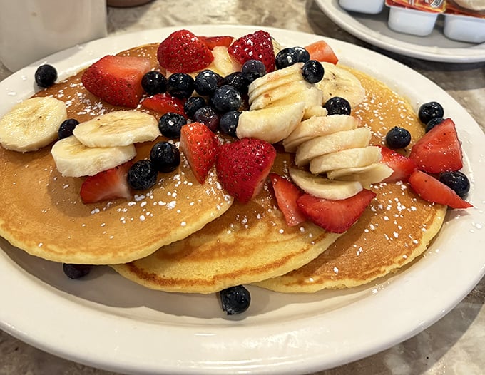 Pancakes that double as edible canvases, adorned with a rainbow of fresh fruit—proof that breakfast can indeed be both art and science.