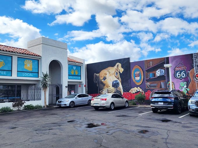 The eye-catching mural featuring a friendly pup adds unexpected charm to the parking area, hinting at the creative treasures inside.