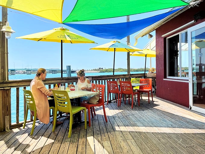 The patio where time slows down and conversations flow as freely as the drinks. Those colorful chairs and umbrellas aren't just furniture—they're vacation enablers.