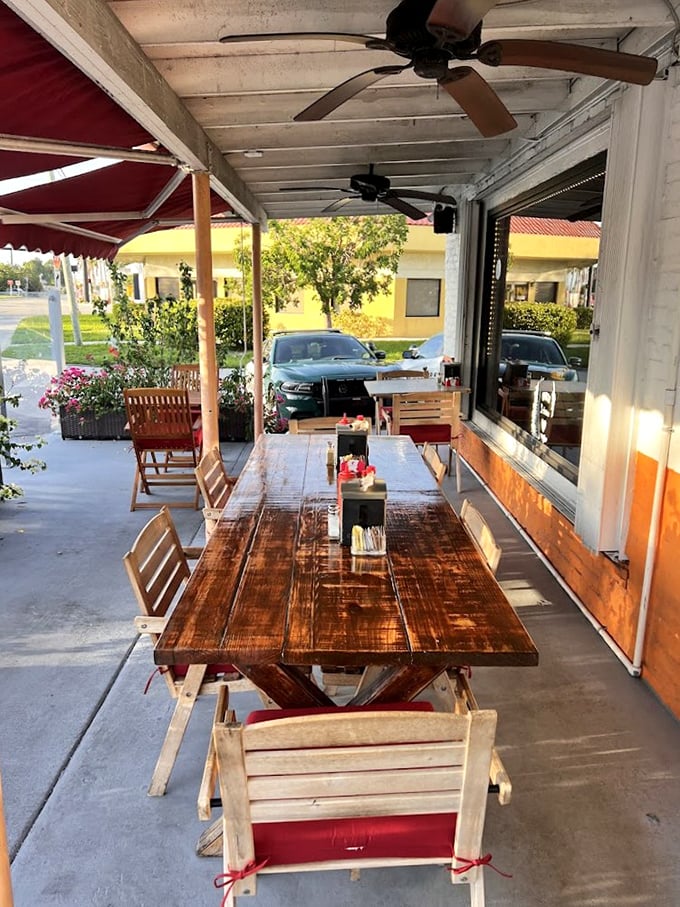 Outdoor dining that captures Florida's breezy charm. That weathered wooden table has heard more breakfast epiphanies than a therapist's couch.