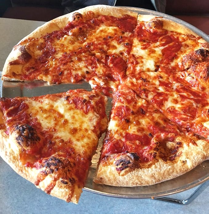 The signature swirl of sauce atop cheese—Grotto's trademark reverse engineering of pizza construction that somehow makes perfect sense.