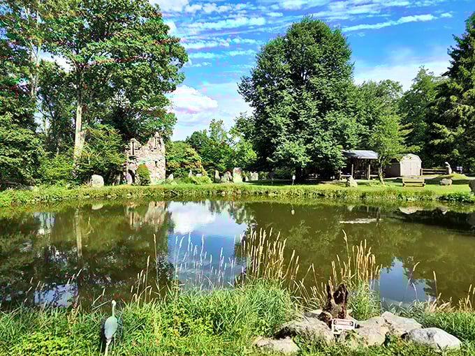 Mirror, mirror on the pond—reflecting stone ruins and summer skies. This tranquil water feature doubles the beauty of Columcille's mystical landscape.