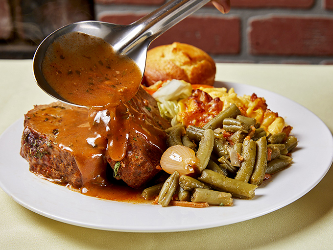 Gravy cascading over meat like a savory waterfall—this is the kind of food moment that deserves its own soundtrack.