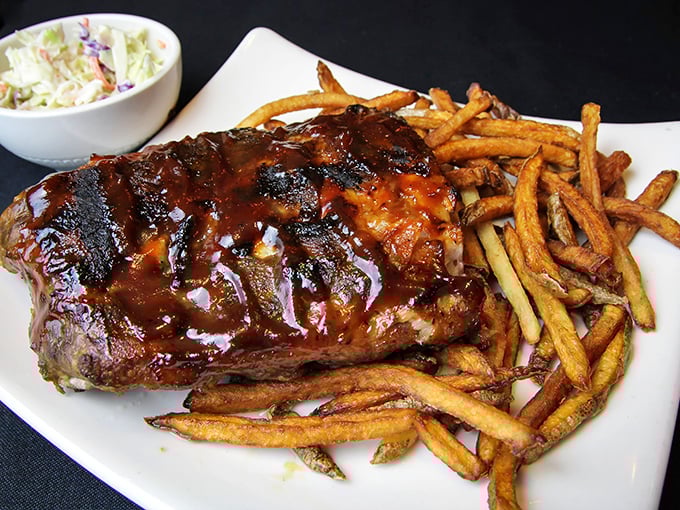 Glistening with sauce and falling off the bone, these ribs don't care about your shirt—they're too busy delivering smoky, sticky satisfaction with every bite.