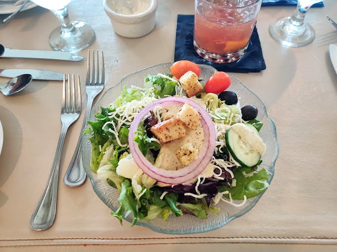 The Rosebud salad brings fresh elegance to a meal built around serious red meat indulgence.