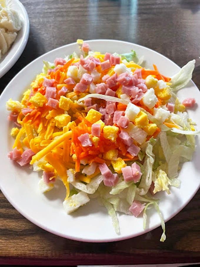A salad that makes a valiant effort to balance out your buffet choices—though we both know it's just a brief detour on your way back to the fried chicken.