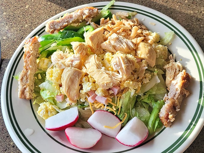 Not just a salad, but a celebration of fried chicken atop garden-fresh ingredients. The radish garnish adds color, as if saying, "See? We're being healthy!"