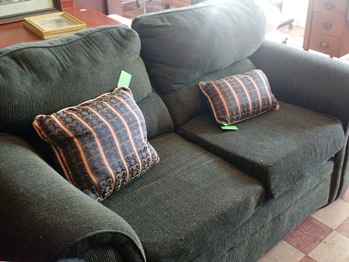 This forest-green sofa hasn't just seen conversations—it's absorbed them, ready to bring its well-earned comfort and subtle '90s charm to your living room.