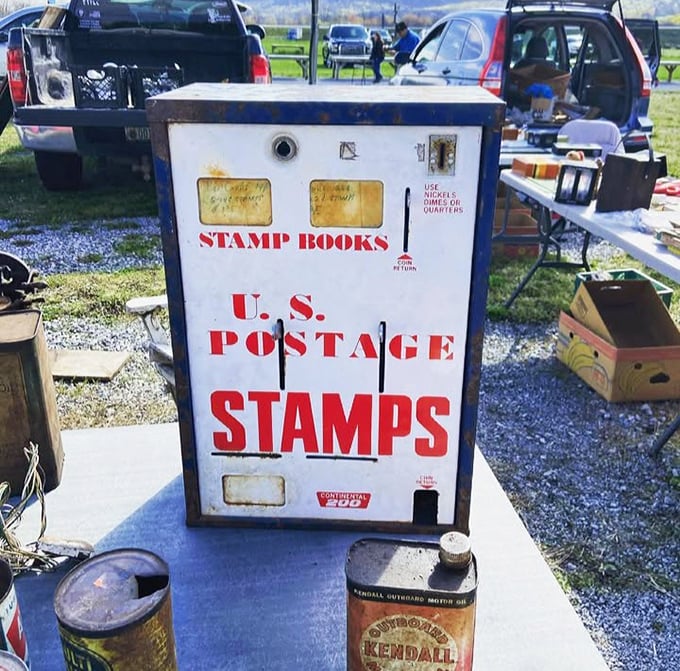 This vintage stamp machine stands as a relic from when mail required licking something, not just clicking something – nostalgia with a side of utility.