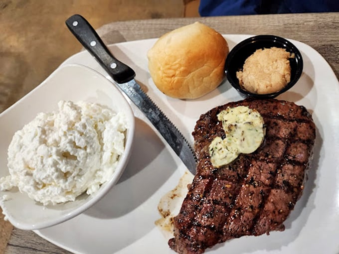A perfectly grilled steak with compound butter slowly melting into each slice—carnivore poetry on a plate.