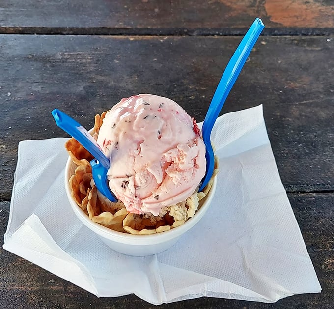 Pink ice cream with a pink spoon on a pink table—Super Scoops commits to its aesthetic with the same dedication they bring to their strawberry flavor.